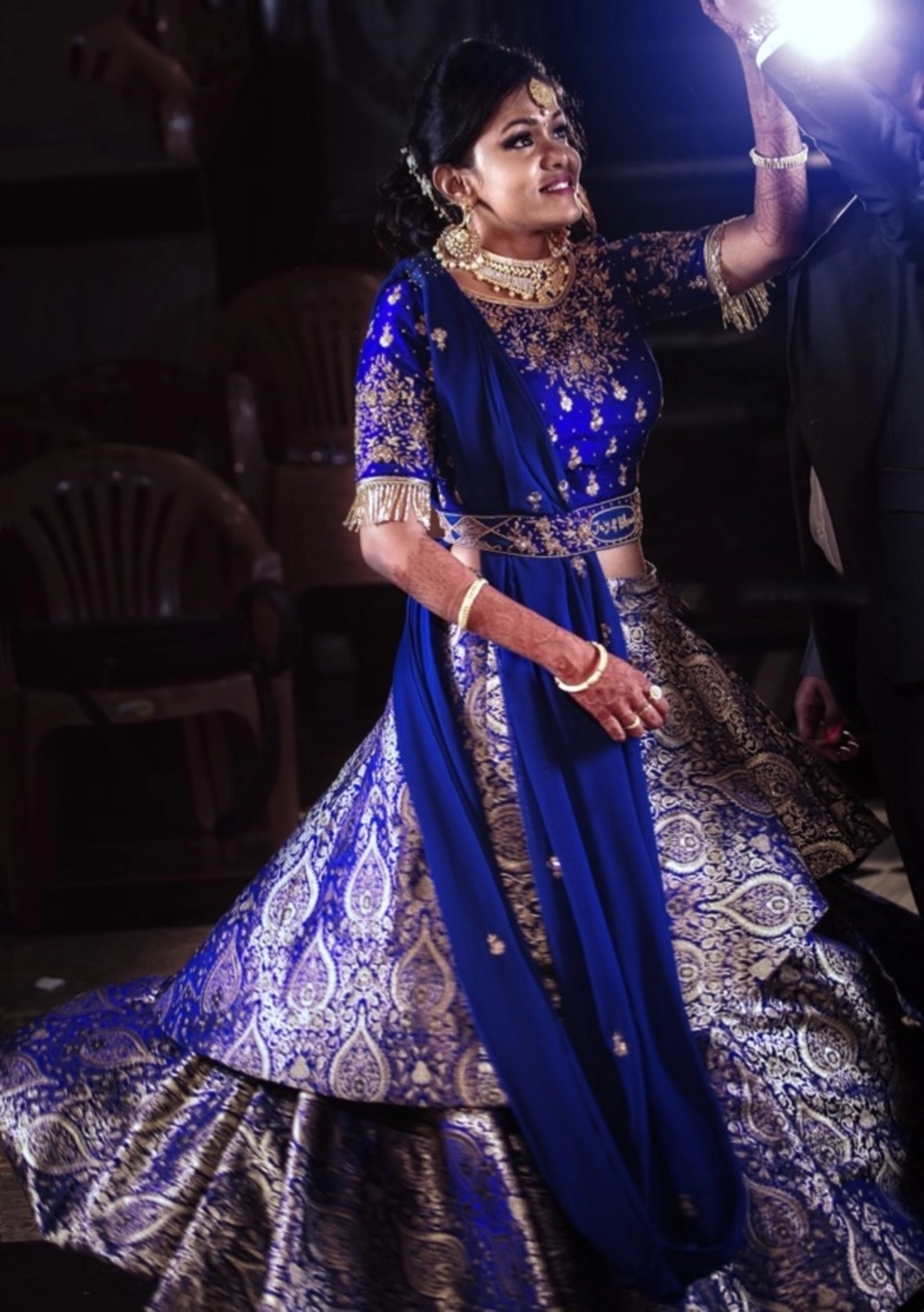 Bride Bhuvana in a navy blue brocade lehenga designed by Archana Karthick